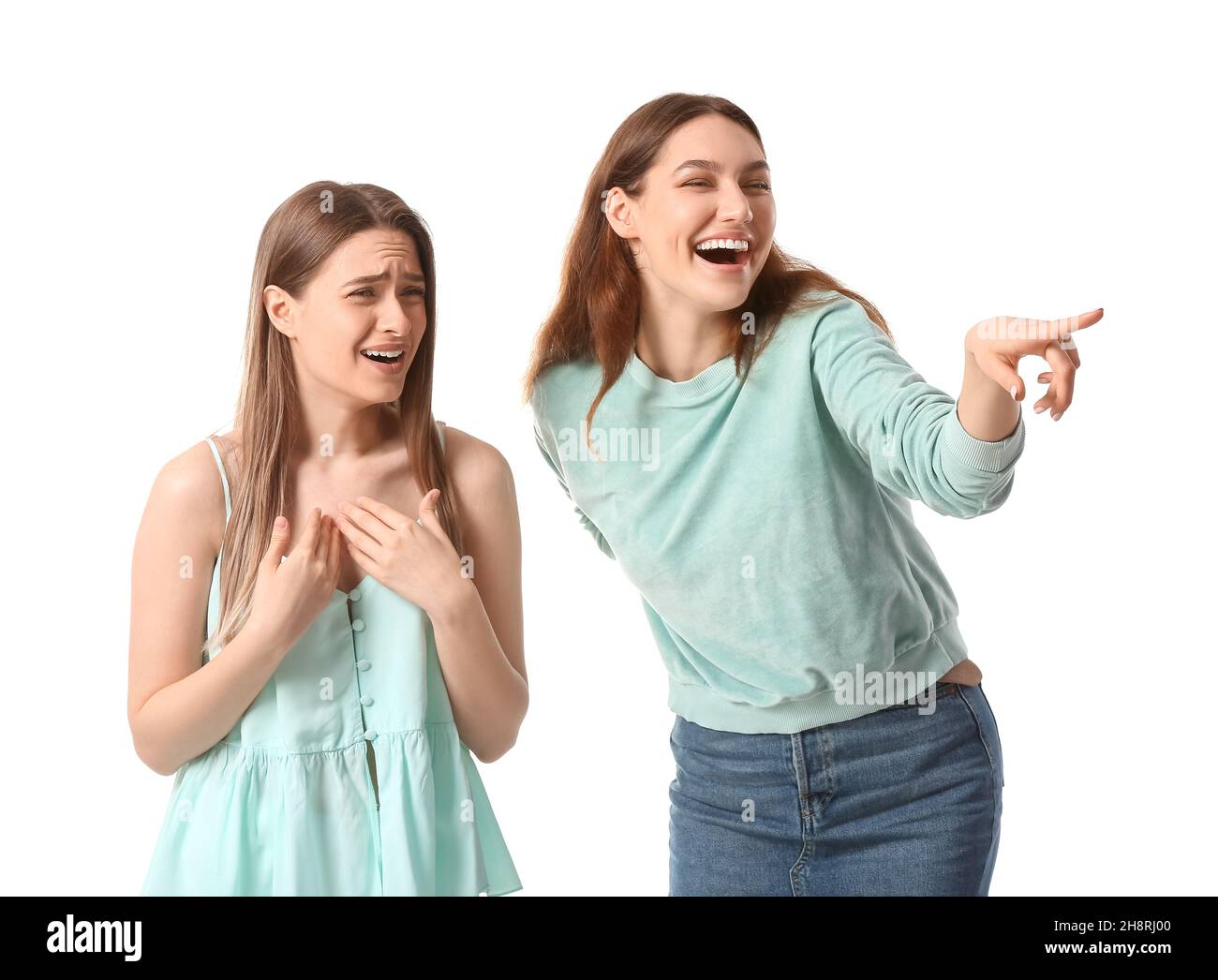 Young gossiping women on white background Stock Photo - Alamy