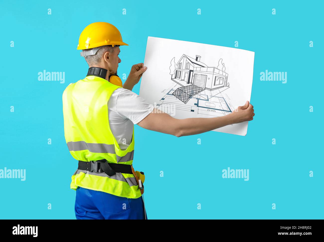 Male builder with drawing on color background Stock Photo - Alamy