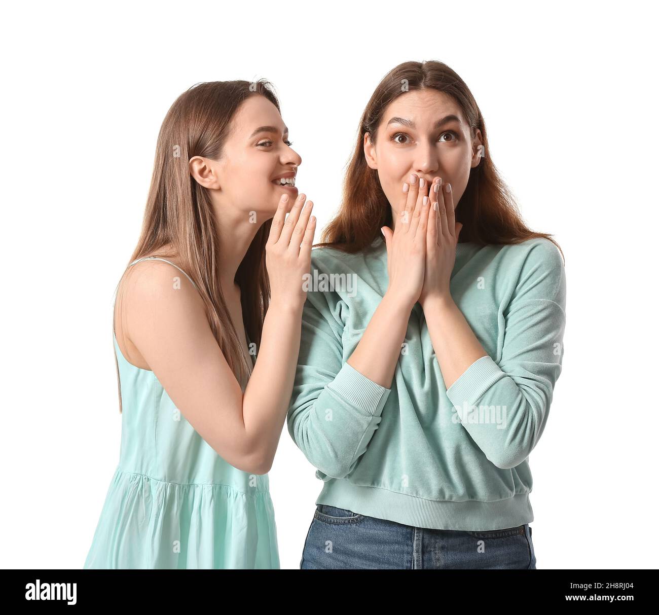 Young gossiping women on white background Stock Photo - Alamy