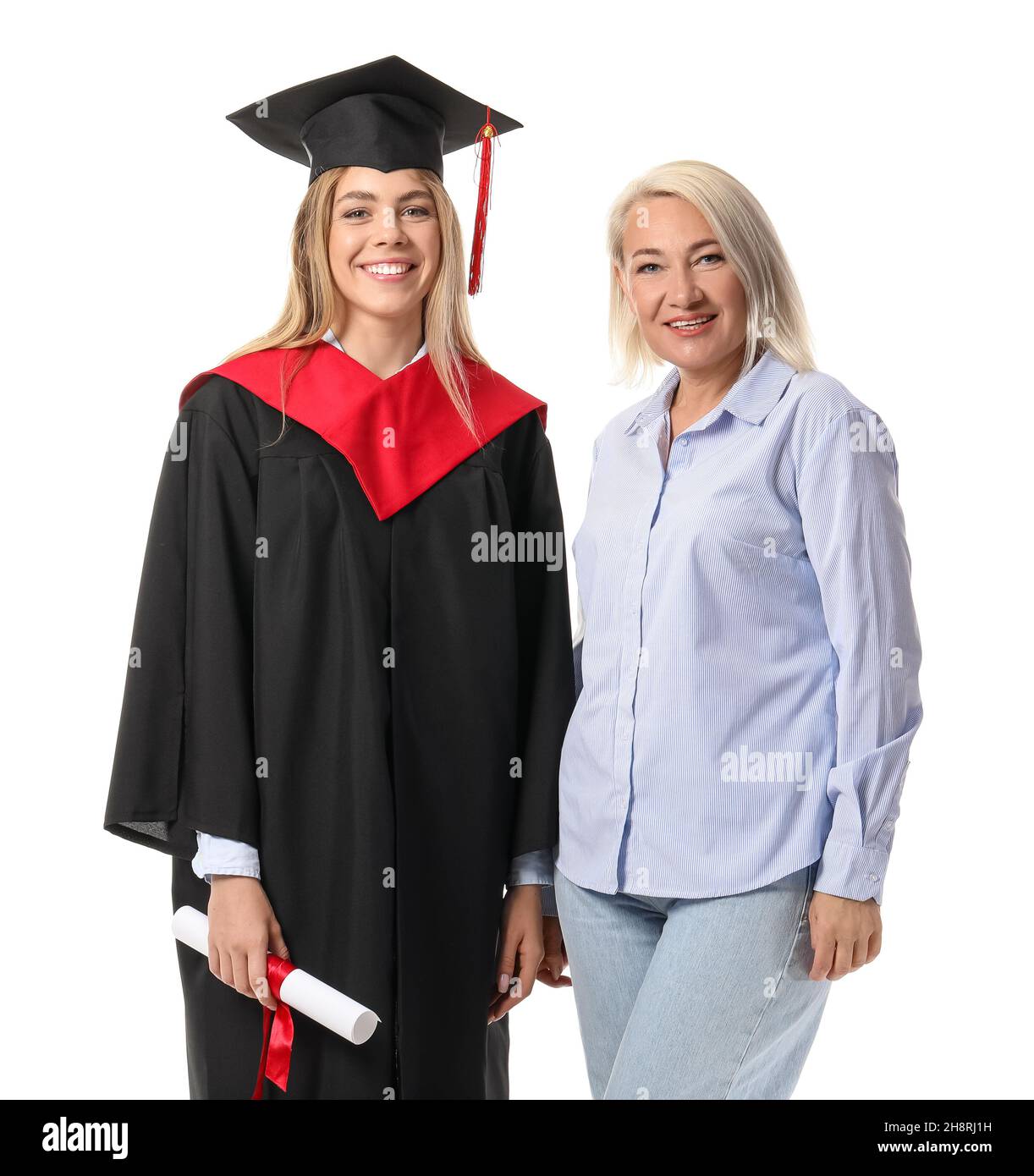 Happy female graduation student with her mother on white background ...