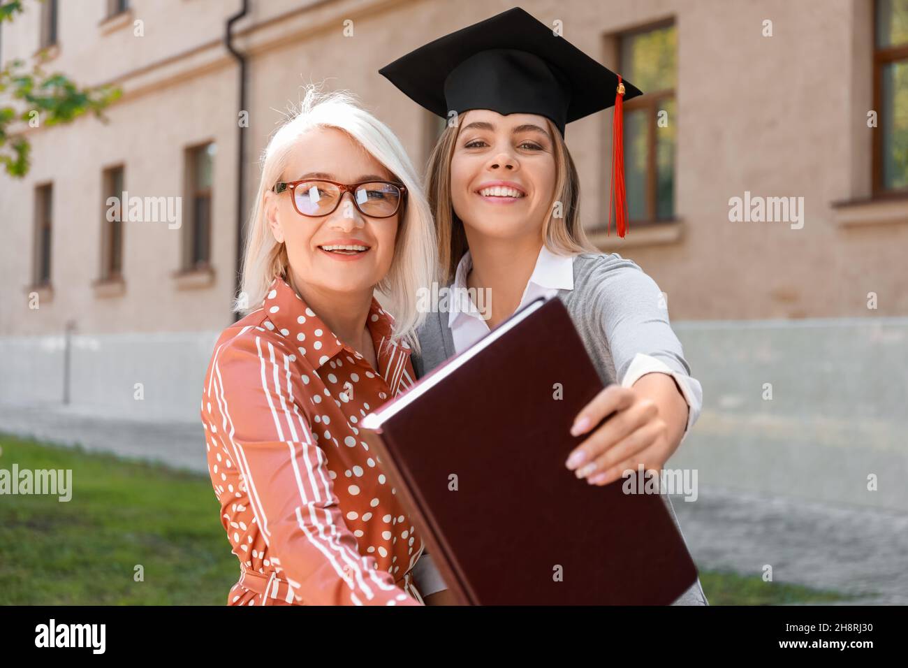 Happy young woman with her mother on graduation day Stock Photo - Alamy