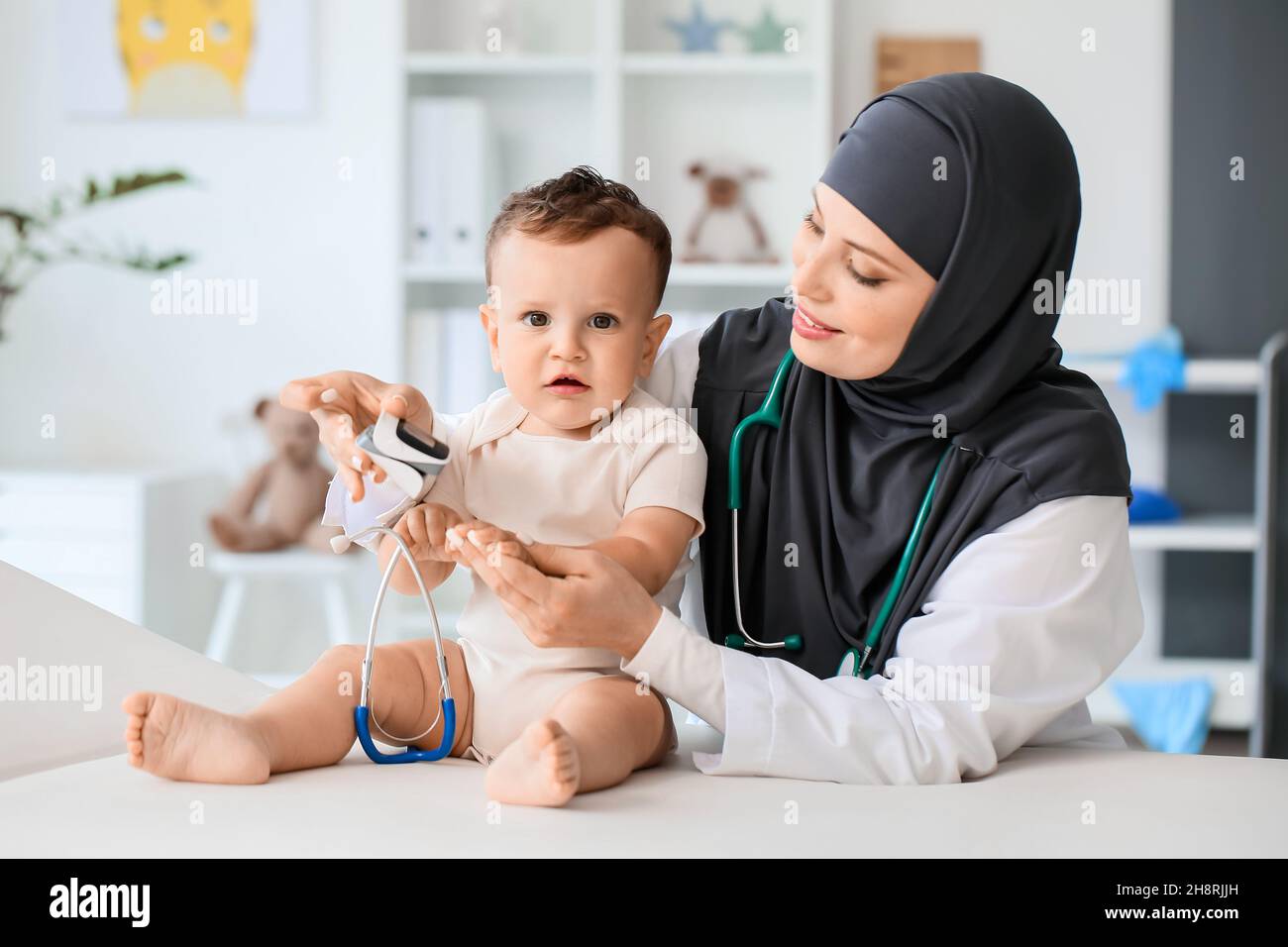 Muslim pediatrician examining baby boy in clinic Stock Photo - Alamy
