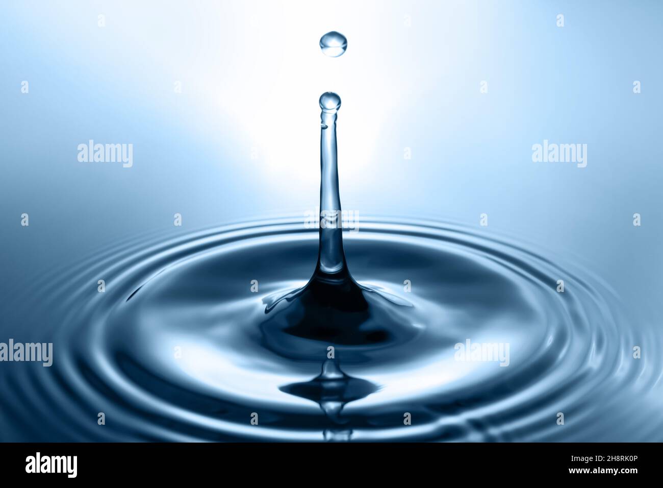 Splash of water on blue background Stock Photo - Alamy