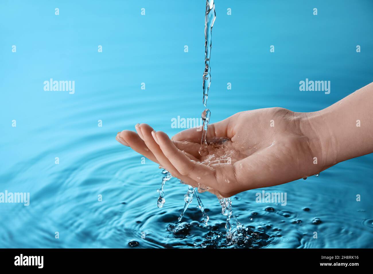 Water pouring in human hand Stock Photo - Alamy