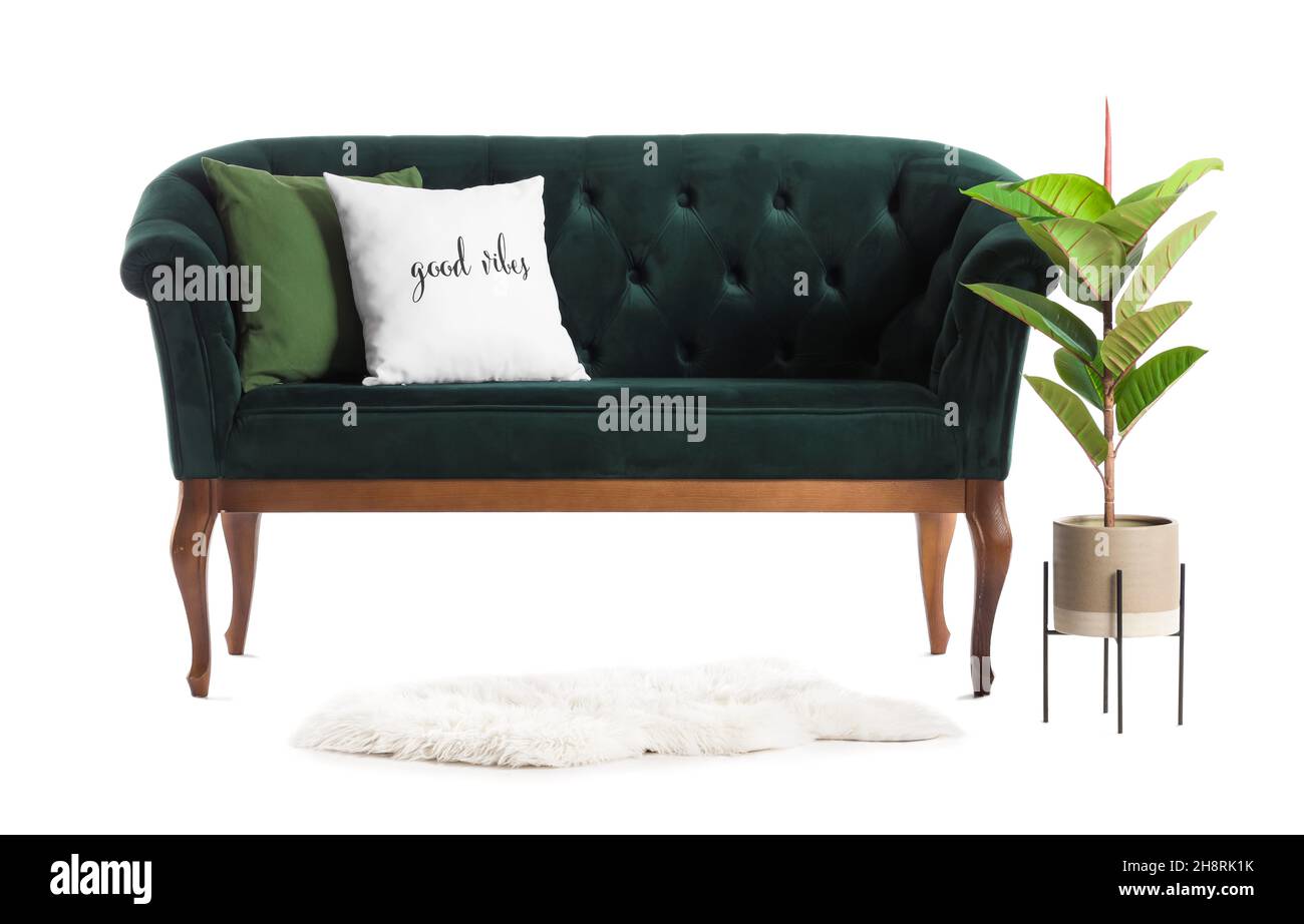 Deep green sofa with pillows and houseplant on white background Stock ...