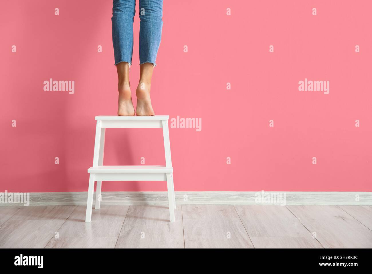 Woman standing on step ladder hi-res stock photography and images - Alamy