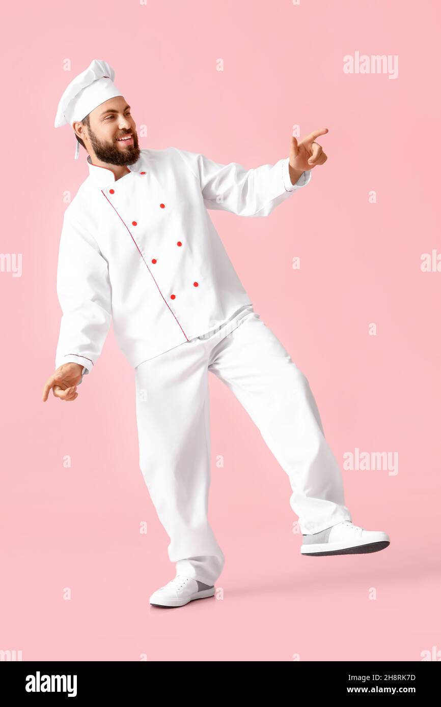 Dancing male chef on pink background Stock Photo - Alamy