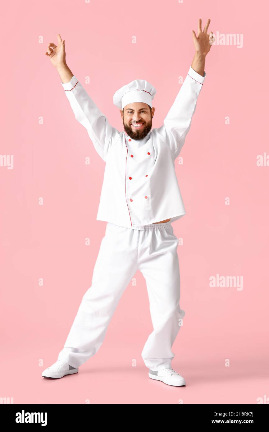 Dancing male chef on pink background Stock Photo - Alamy