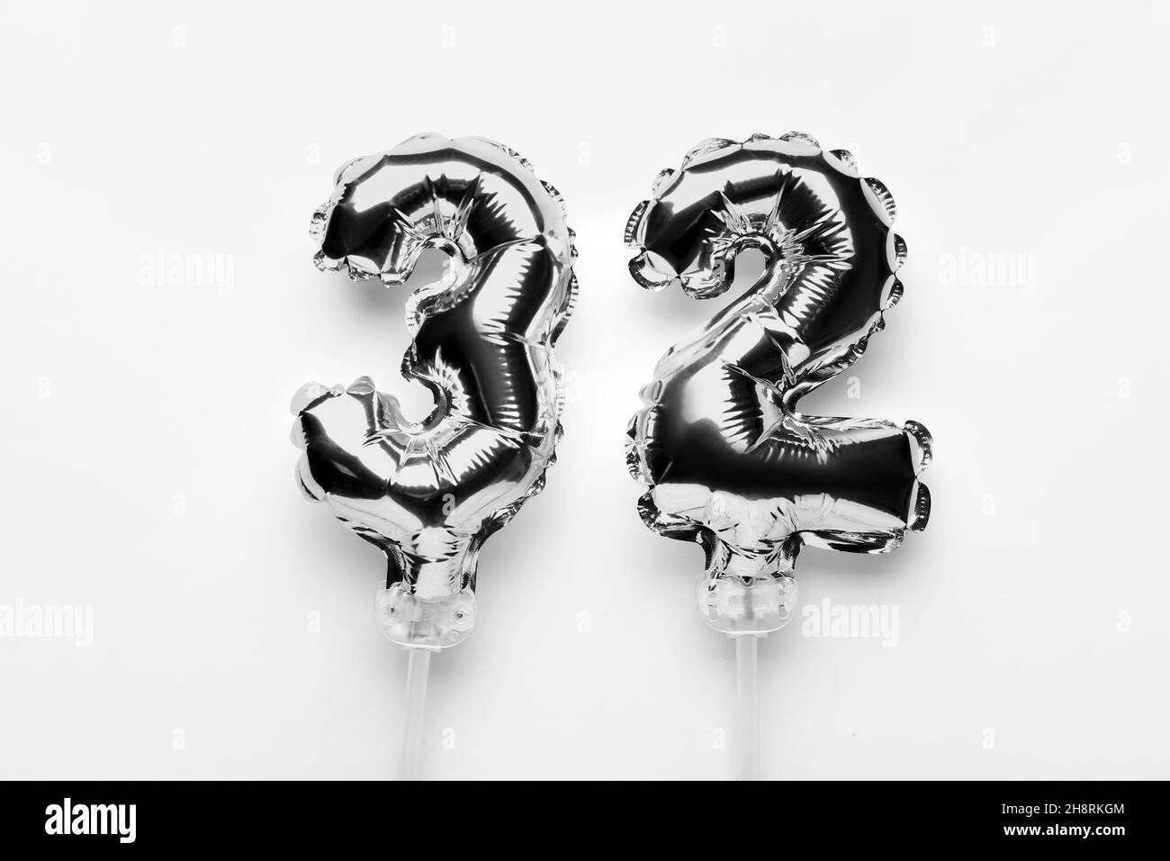 Figure 32 made of silver balloons on light background Stock Photo - Alamy