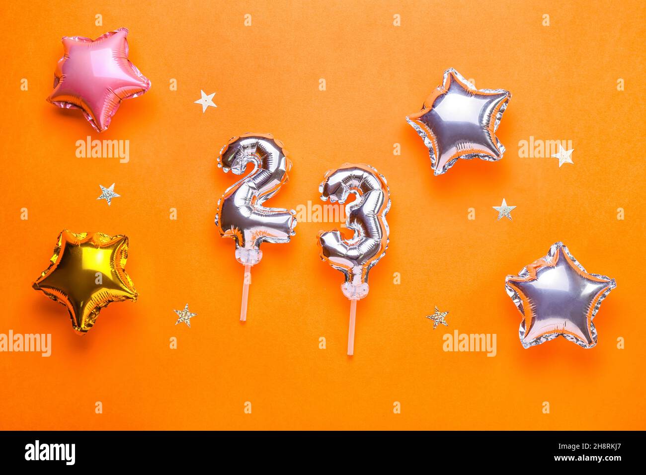 Figure 23 and star shaped balloons on color background Stock Photo - Alamy