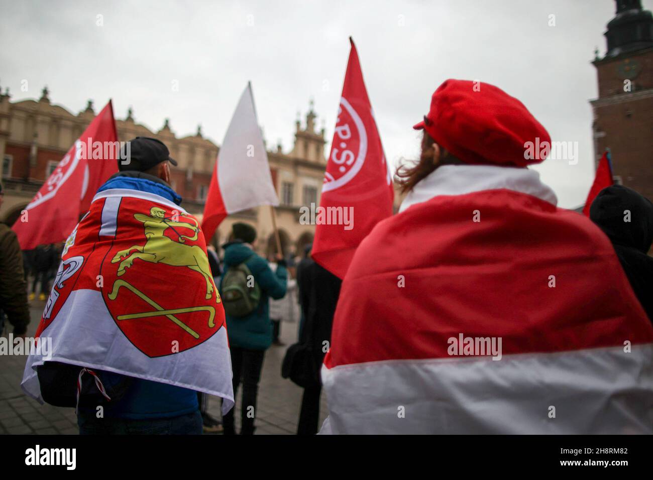 Protesters wrapped with Polish flags take part during the demonstration ...