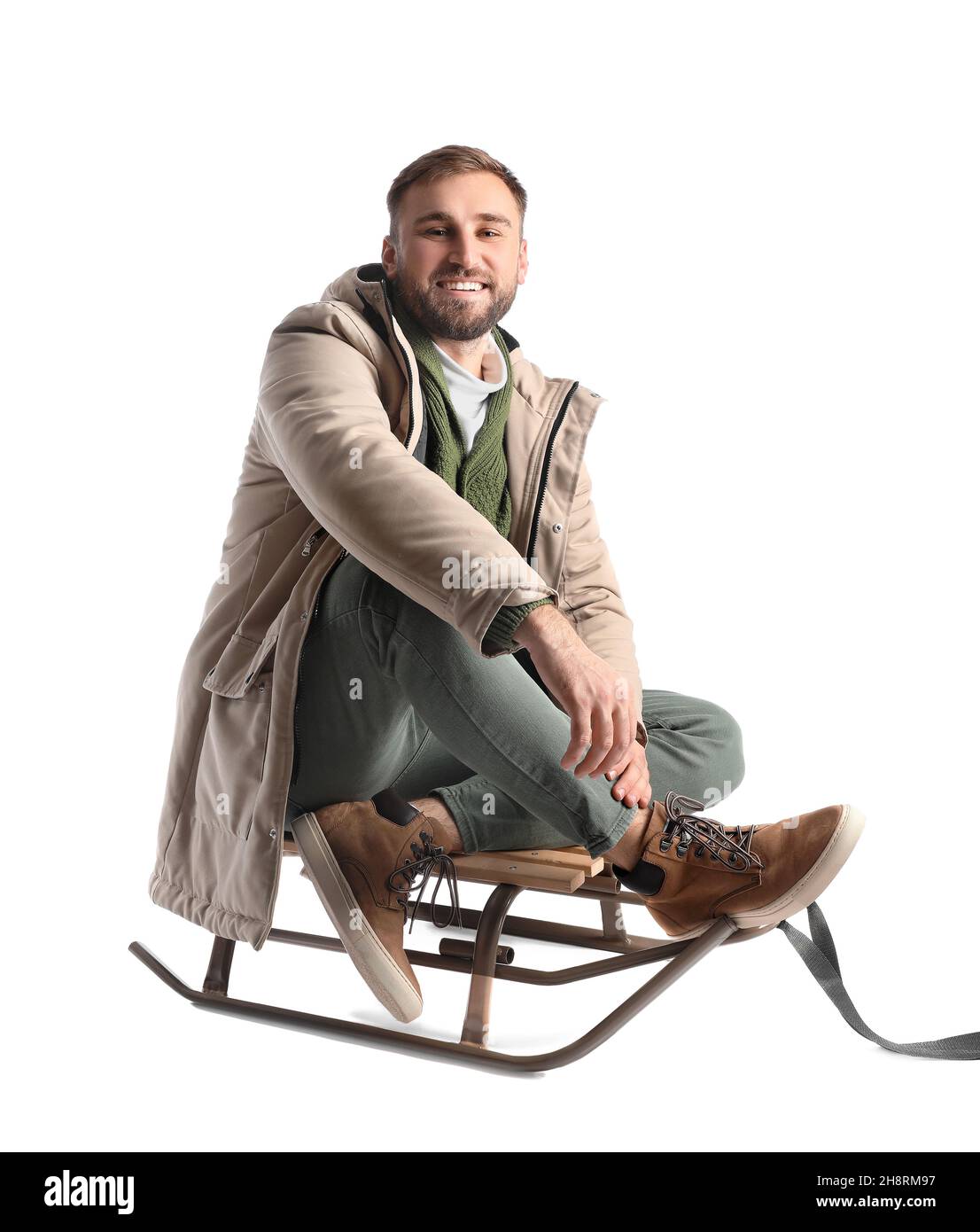 Young man with sled on white background Stock Photo - Alamy