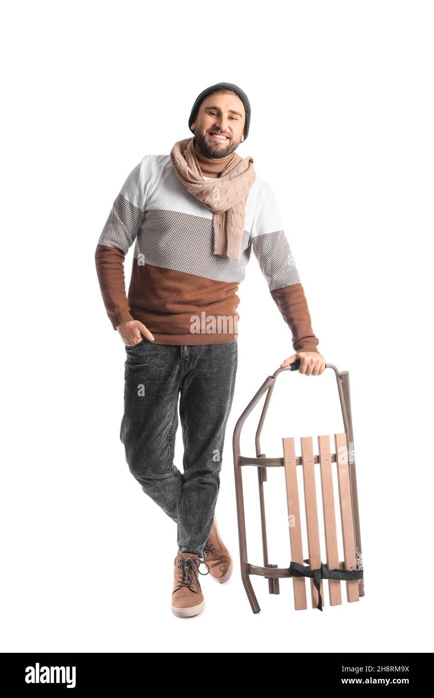 Young man with sled on white background Stock Photo - Alamy