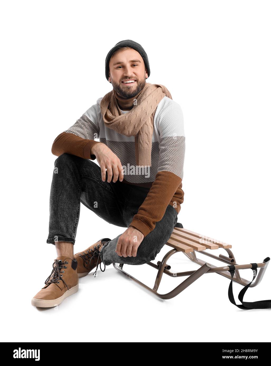 Young man with sled on white background Stock Photo - Alamy