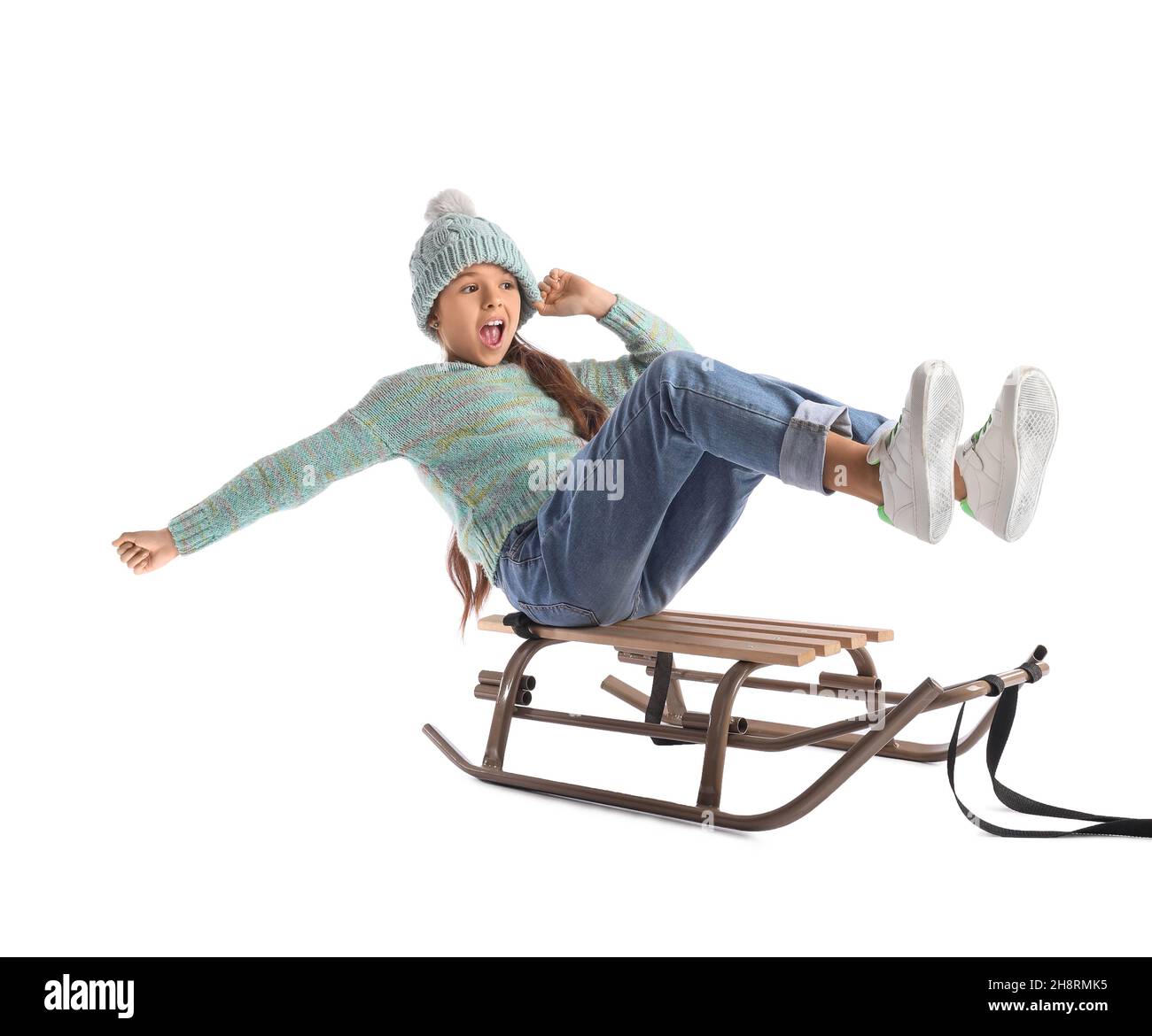 Sledding little girl on white background Stock Photo - Alamy