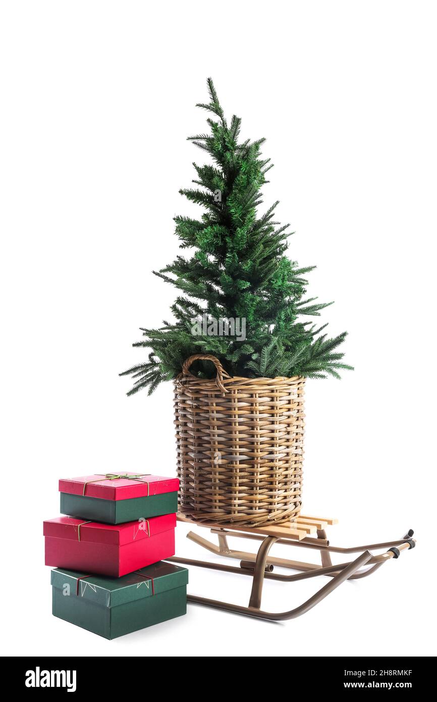 Sled with Christmas tree and gifts on white background Stock Photo - Alamy