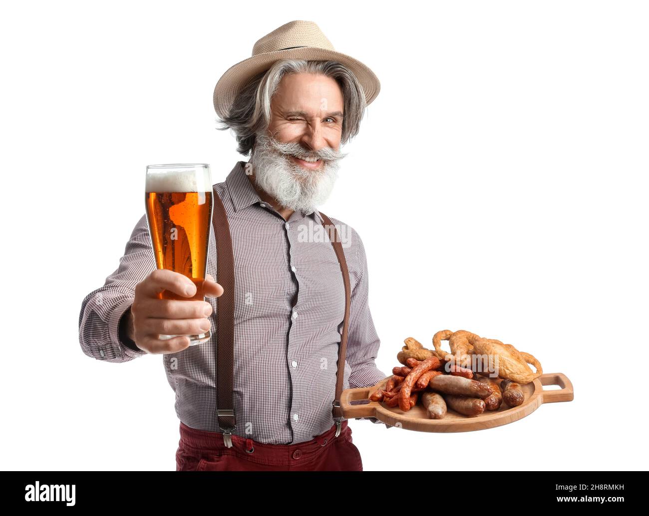 Senior man in traditional German clothes, with beer and snacks on white ...