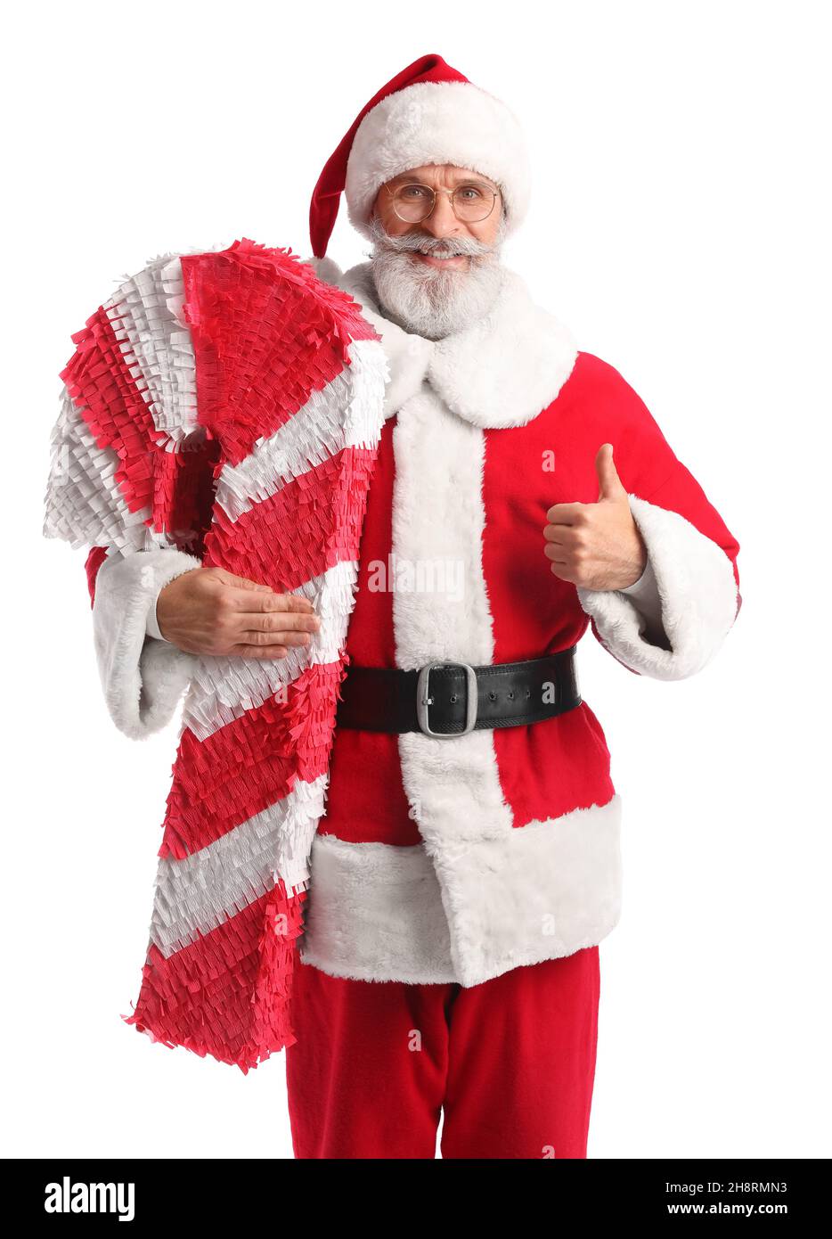 Santa Claus with candy cane pinata showing thumb-up on white background ...
