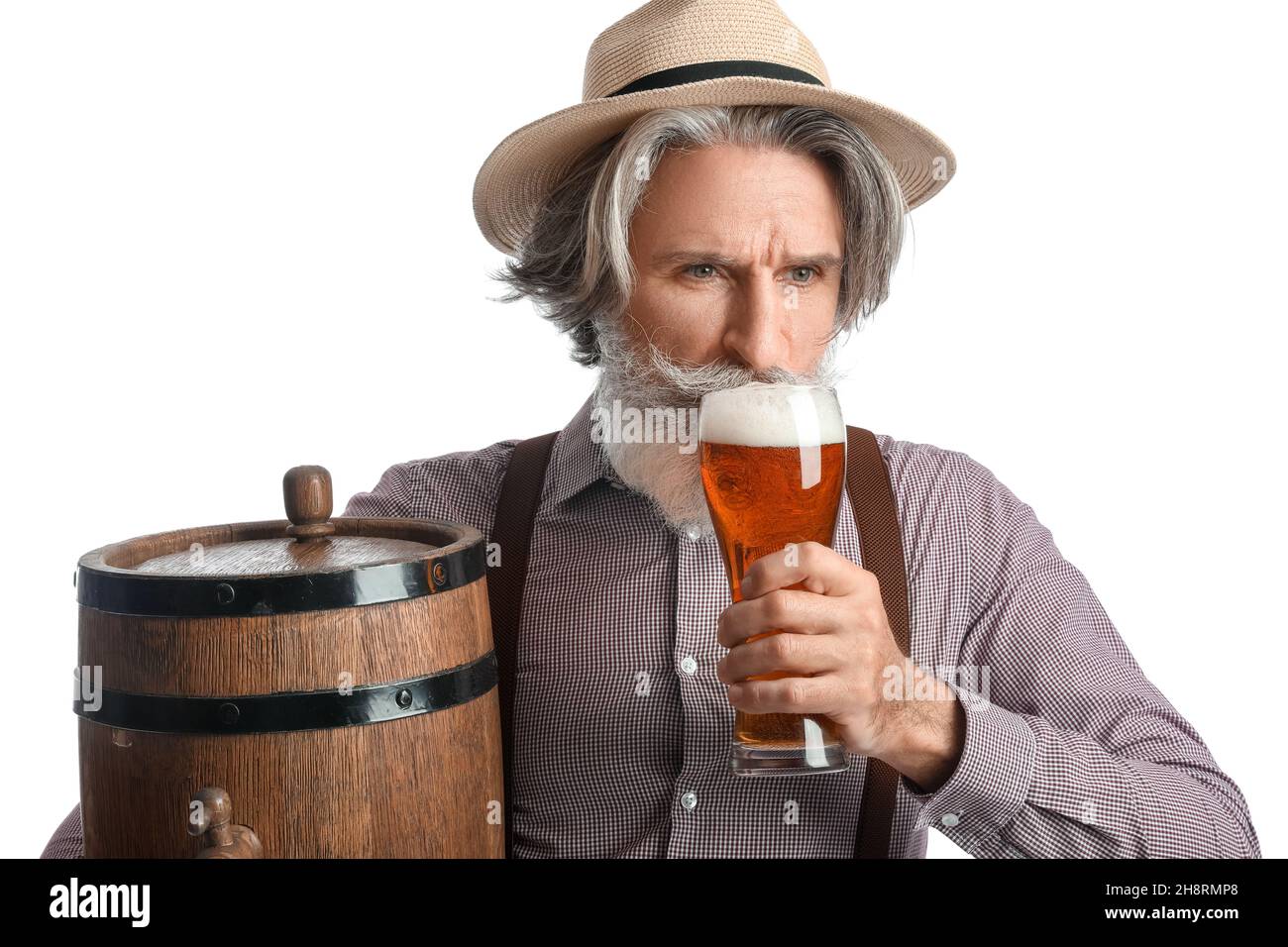 Senior man in traditional German clothes and with beer on white ...