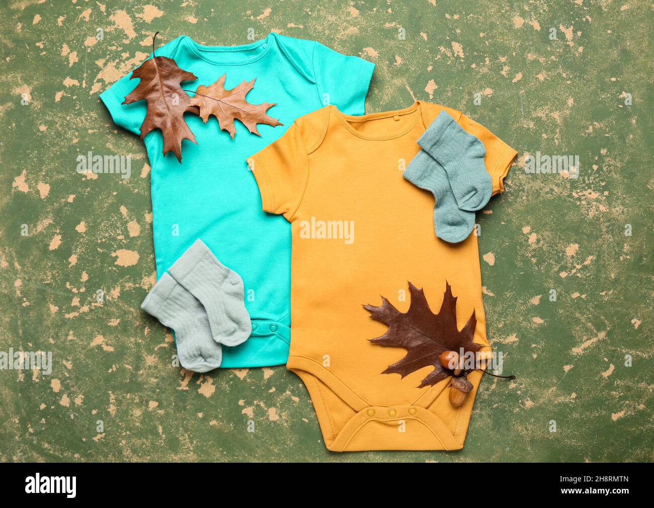 Baby clothes and autumn leaves on color background Stock Photo - Alamy