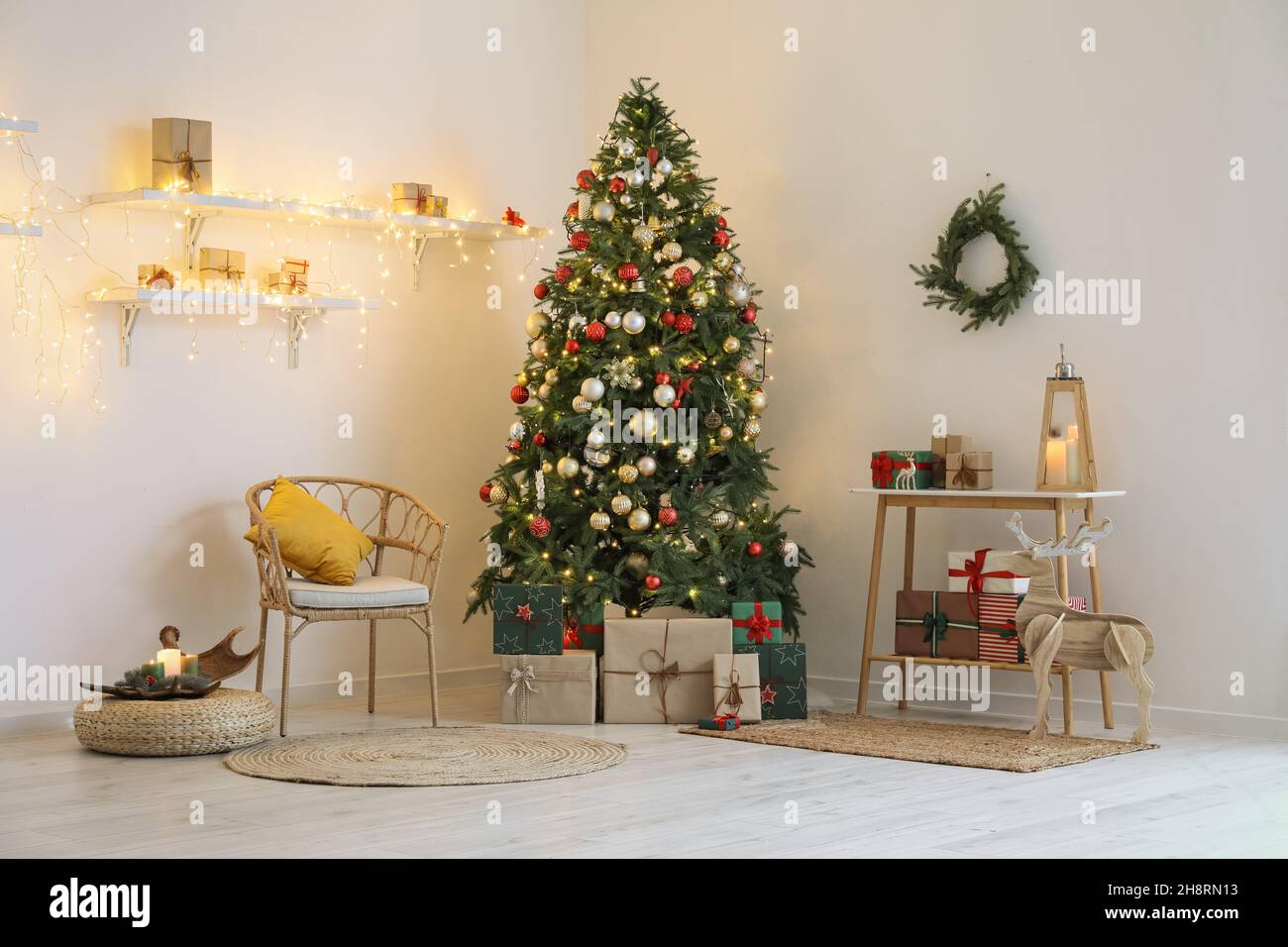 Interior of modern room with Christmas tree, chair and shelf unit Stock ...