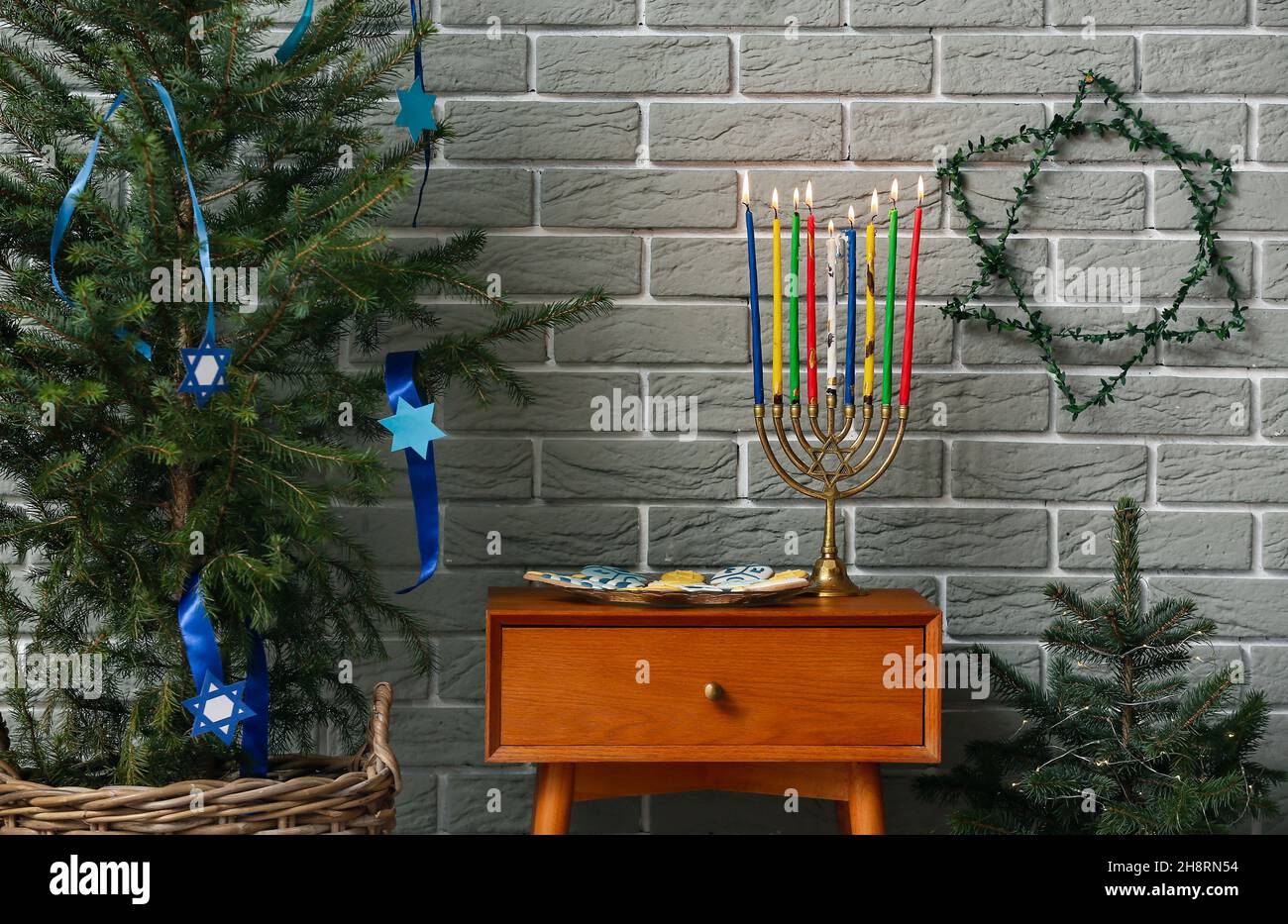 Menorah and cookies for Hanukkah celebration with Christmas trees in ...