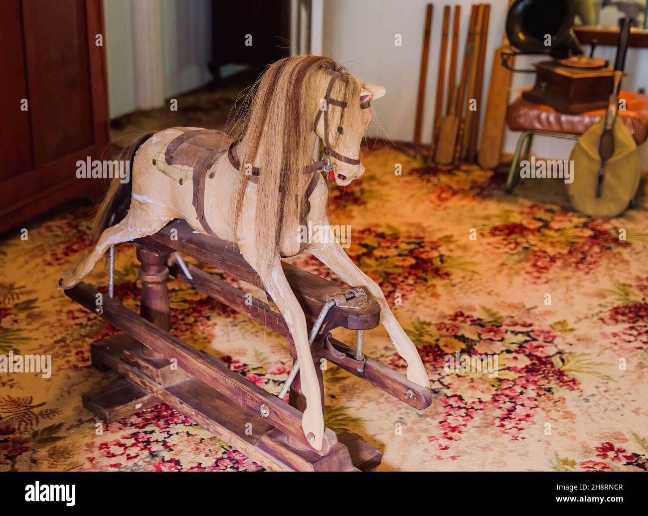 A child rocking horse in the bedroom of historical homestead - grain ...