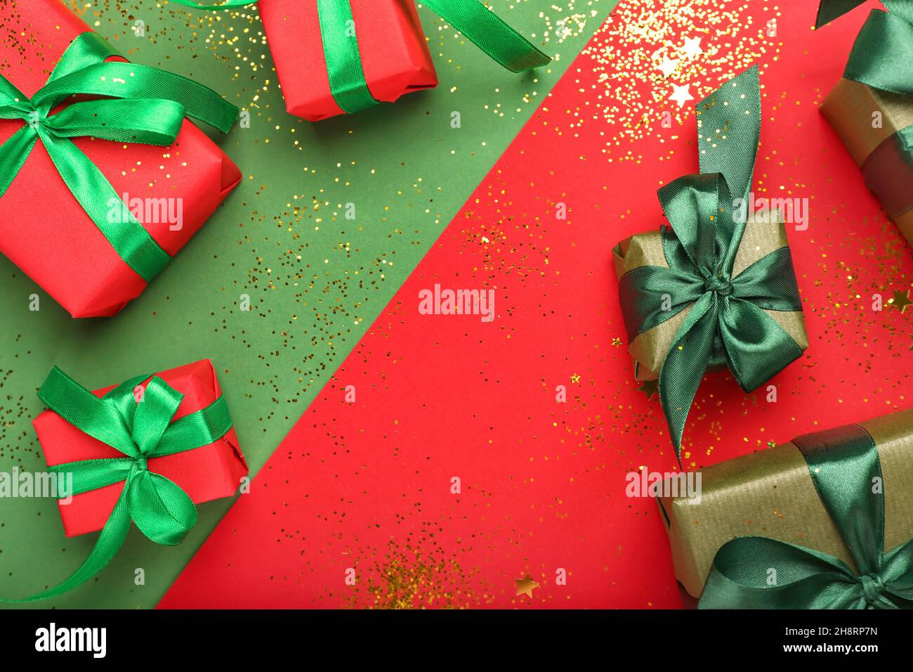 Many Christmas gifts on color background Stock Photo - Alamy