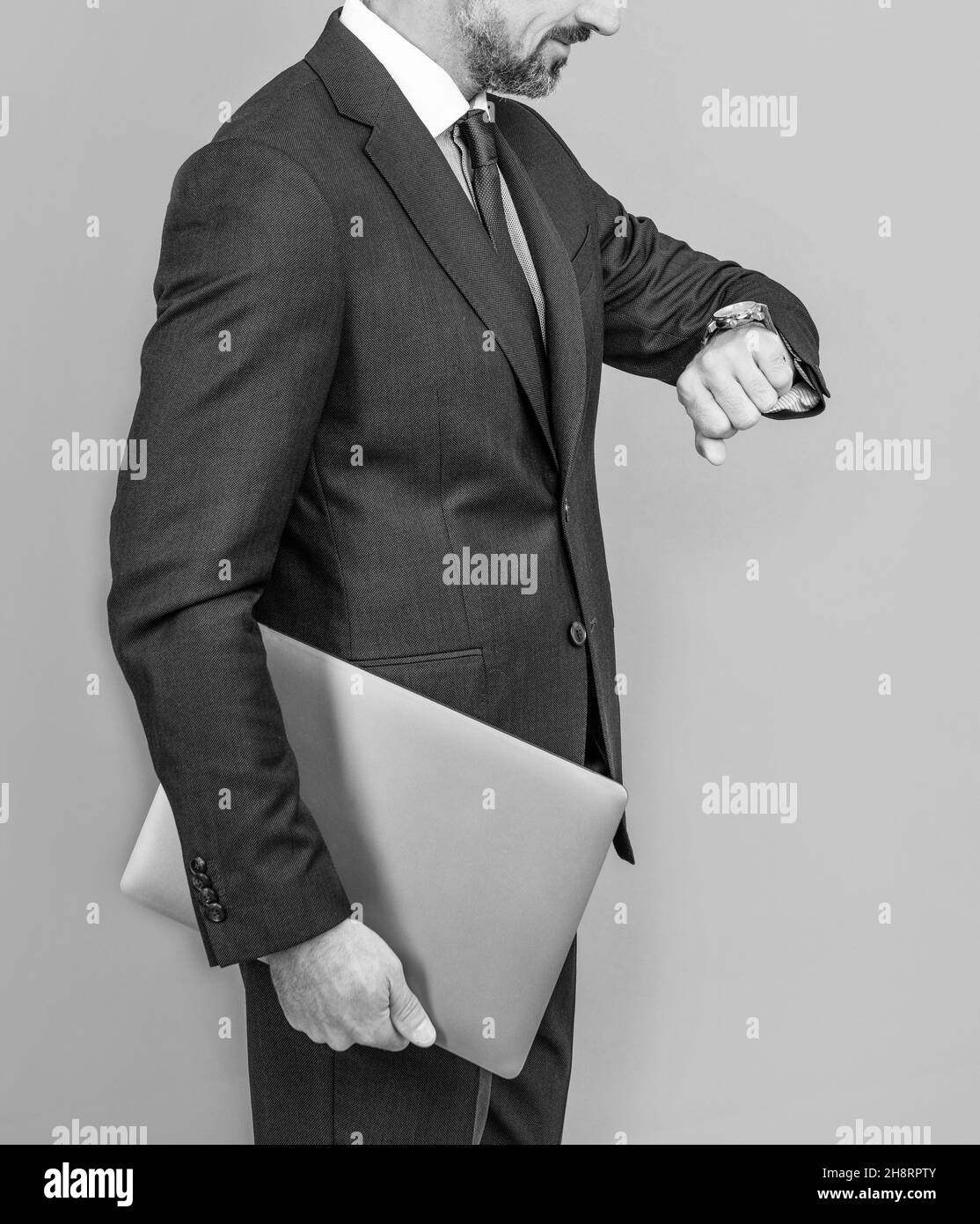 Businessman checking watch in office Black and White Stock Photos ...