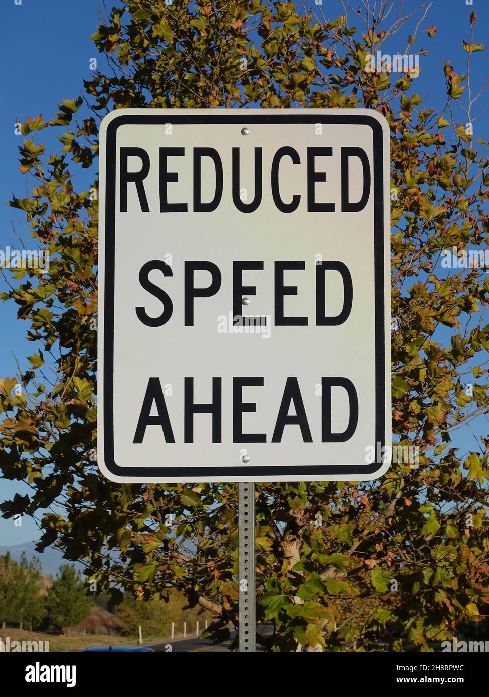 Reduced Speed Ahead Sign on side of road Stock Photo - Alamy