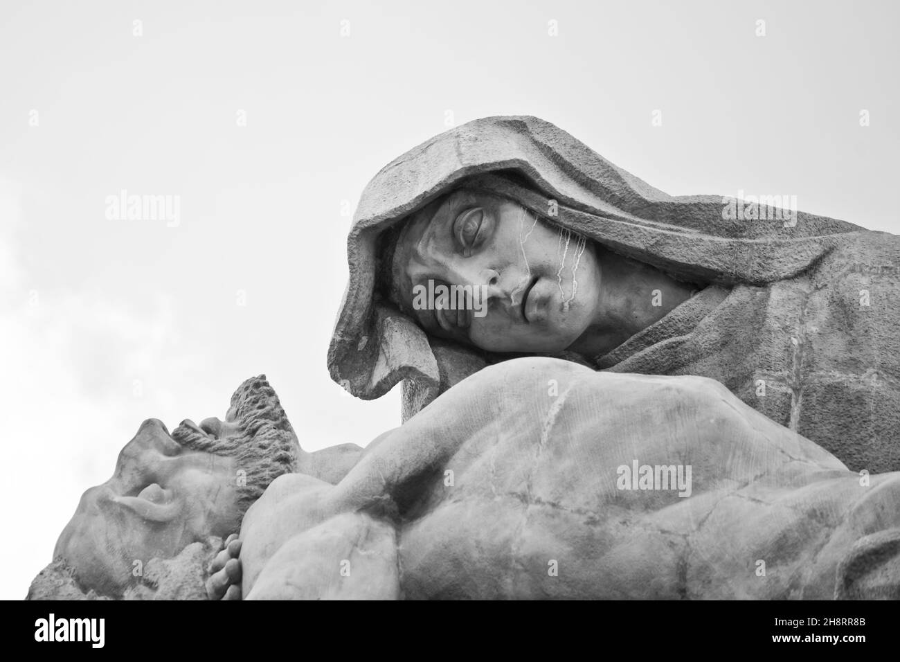 Grayscale closeup shot of a religious statue in Valley of the Fallen in ...