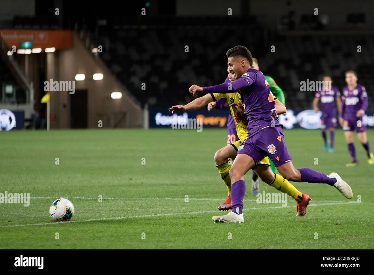 Perth Glory forward Dane Ingham (23) and Wellington Phoenix midfielder ...