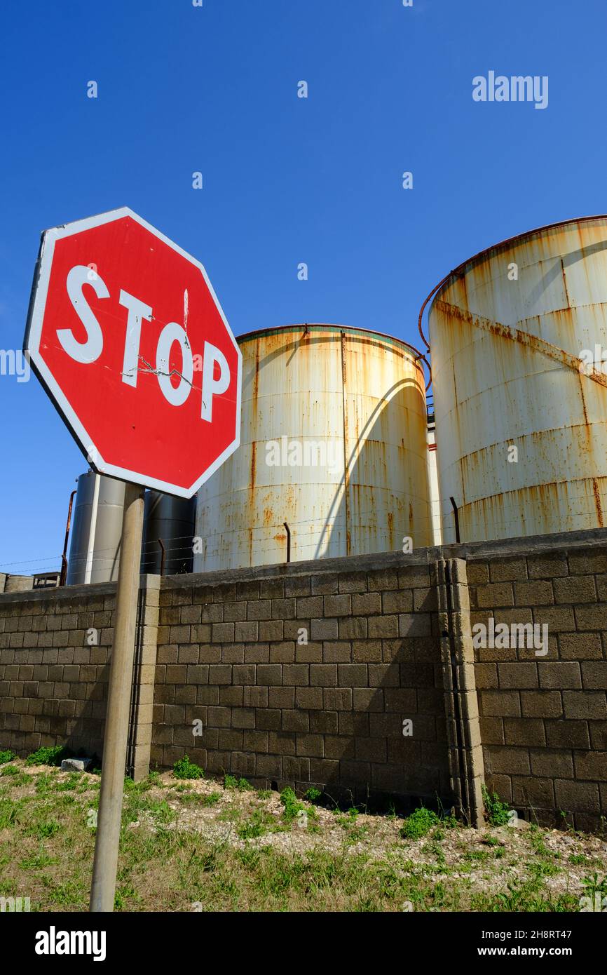 STOP sign next to the area of fuel storage tanks Stock Photo - Alamy