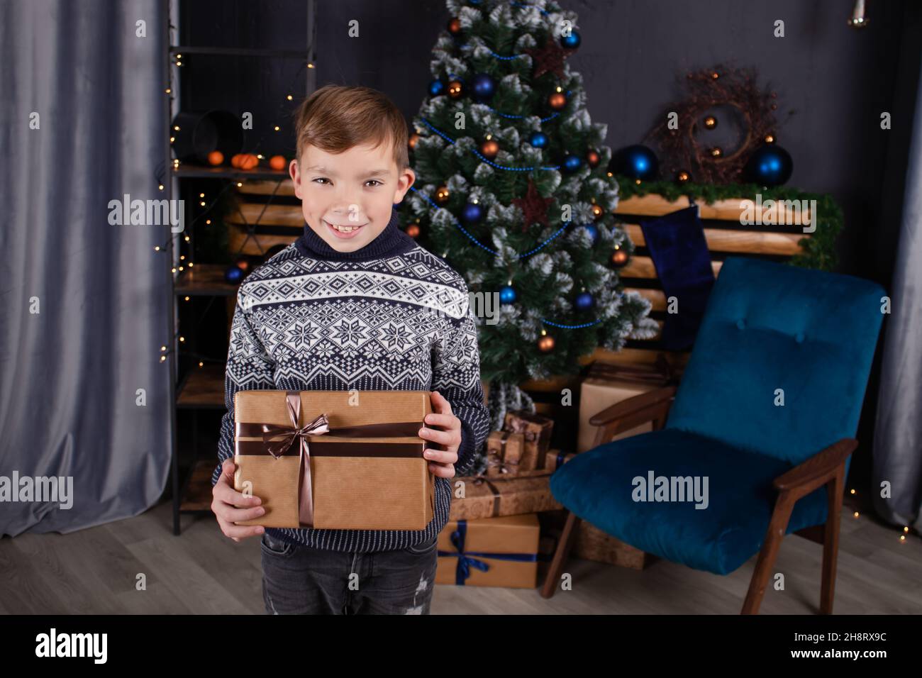 happy handsome pretty teenage blonde boy in knitted sweater holding new ...