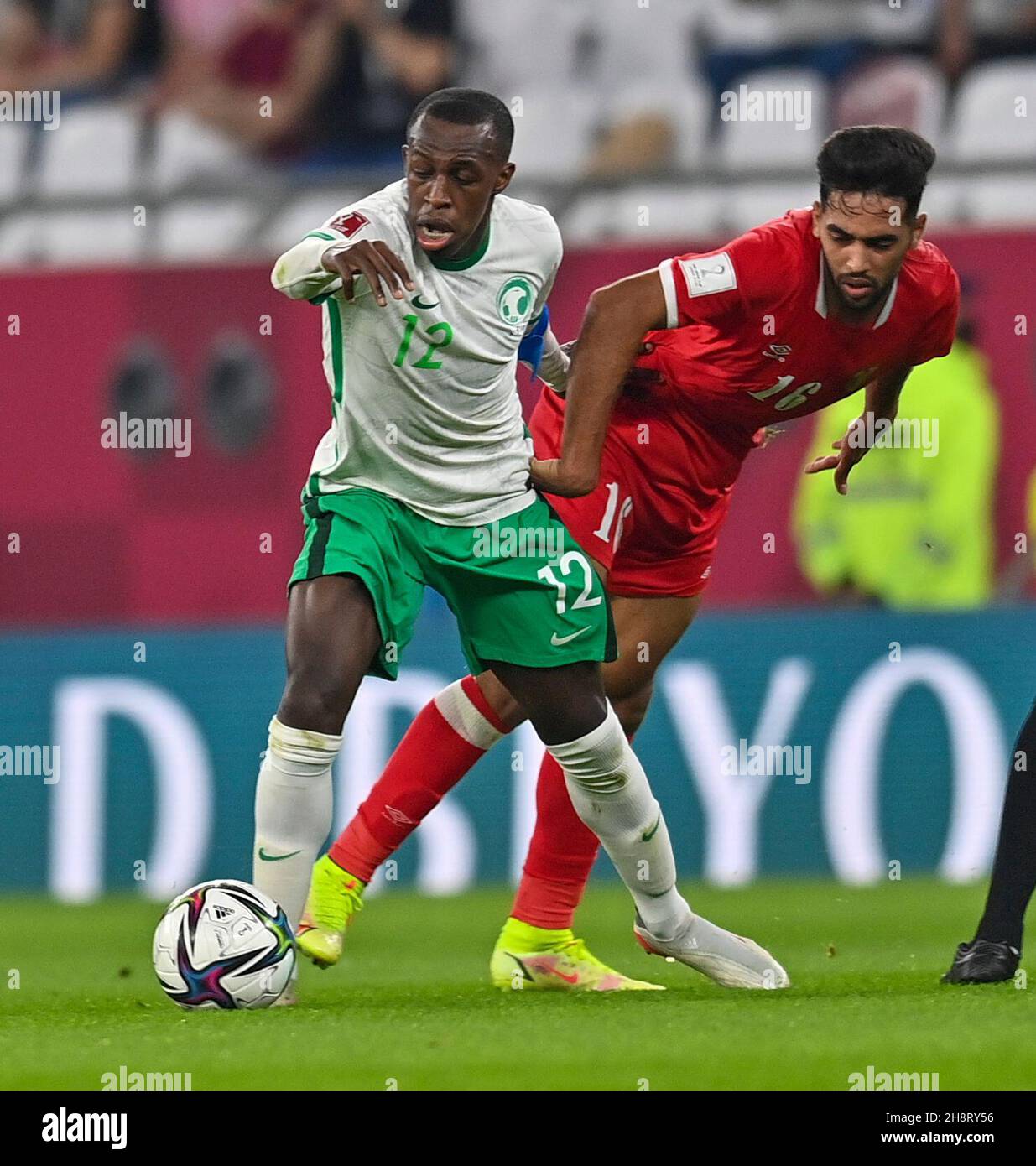 Al Rayyan, Qatar. 1st Dec, 2021. Saud Abdulhamid (L) of Saudi Arabi ...
