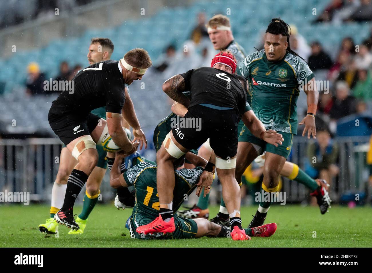 Irae Simone of the Wallabies has the ball taken by Sam Cane of the All ...