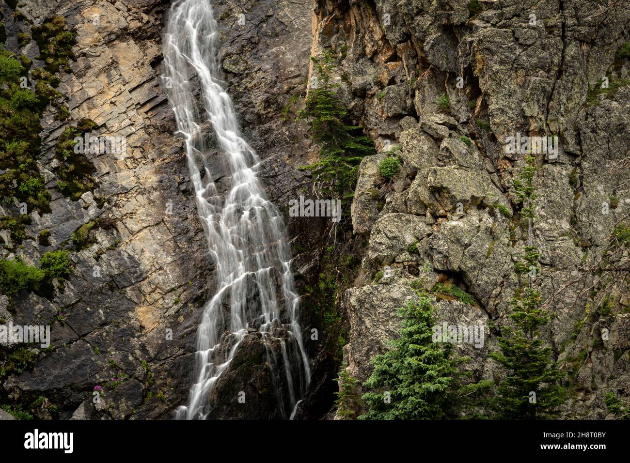 White Stream of Water Falling Over Steep Cliff Face in Rocky Mountain ...