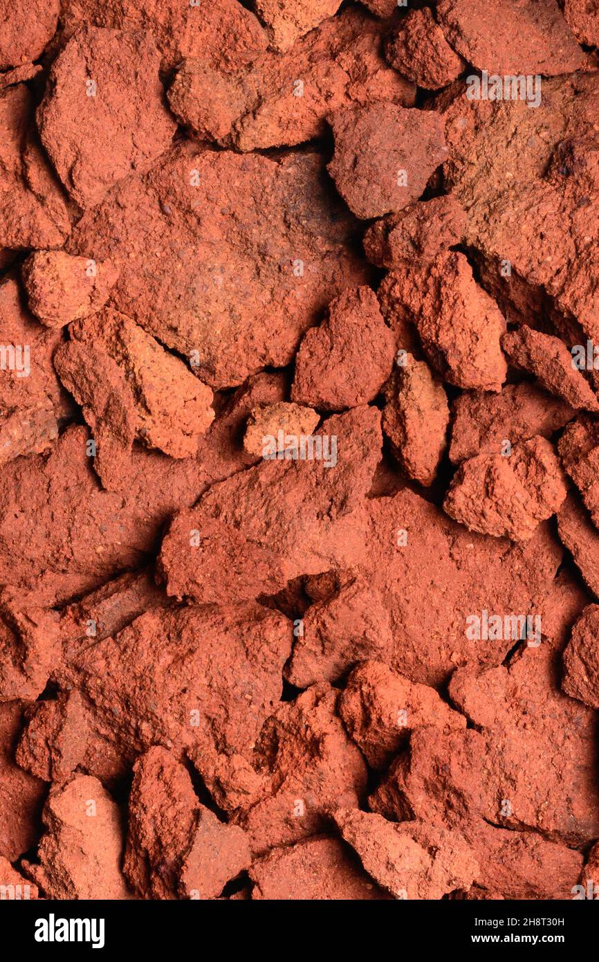 abstract of red clay soil, copper oxide contained rock in deep red ...