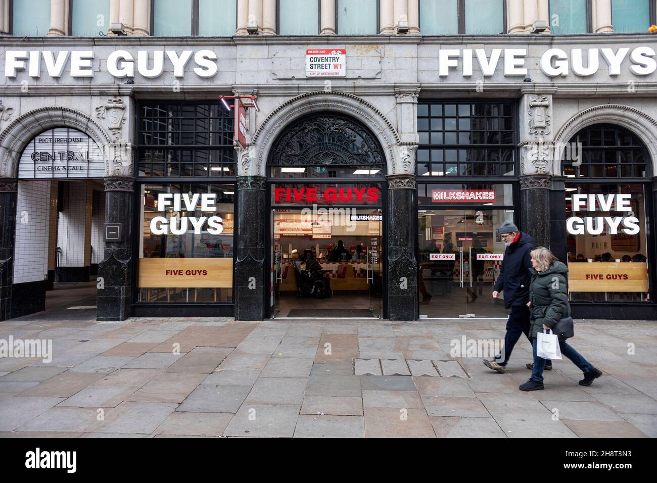 London, UK. 01st Dec, 2021. People walk past a Five Guys store on ...
