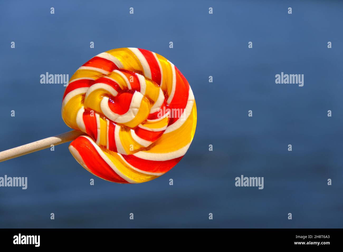 Colorful rainbow lollipop and nature background. High quality photo ...