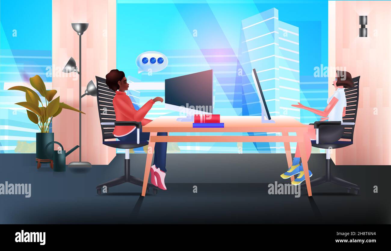 businesswomen using computers at workplace chat bubble communication ...