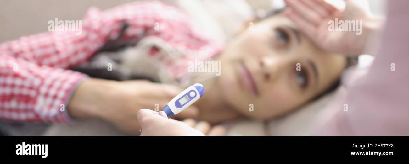 Young woman lying on bed had fever and chills closeup Stock Photo - Alamy