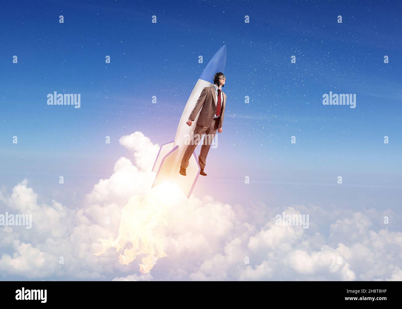 Business person in aviator hat flying on rocket Stock Photo - Alamy