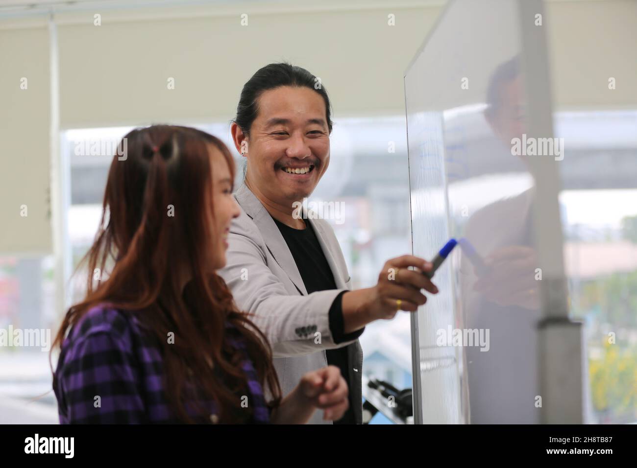 Tutor with cheerful young woman student teaching sound phonetic note on ...