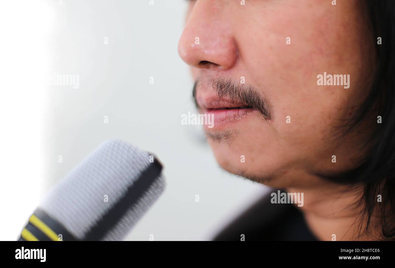 Man singing into microphone hi-res stock photography and images - Alamy