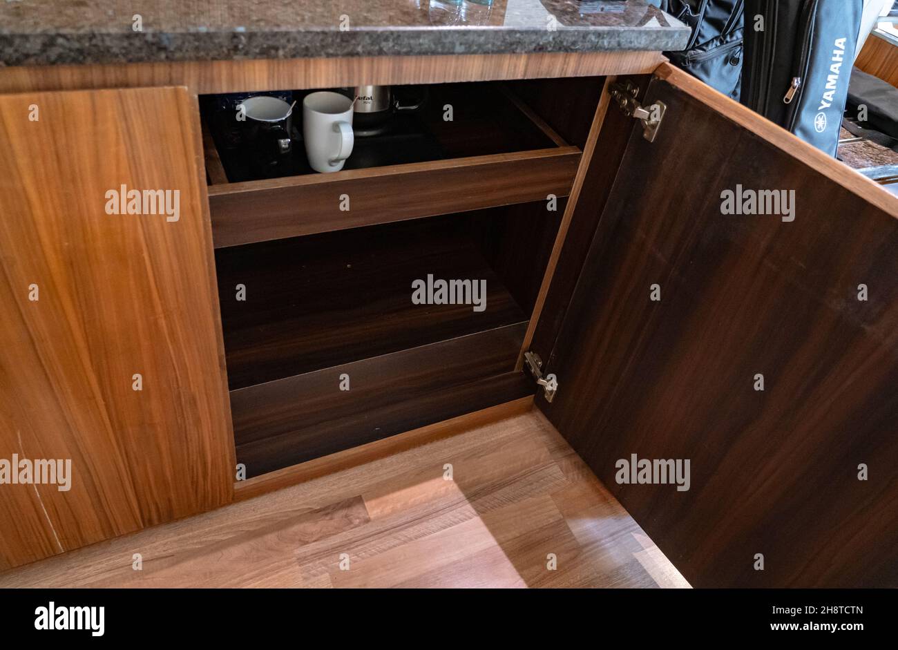 An open wooden cupboard in a storage cabinet Stock Photo - Alamy