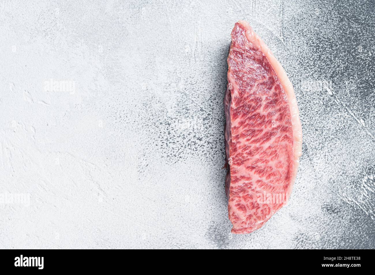 Raw wagyu rump sirloin steak, kobe beef meat. White background. Top ...