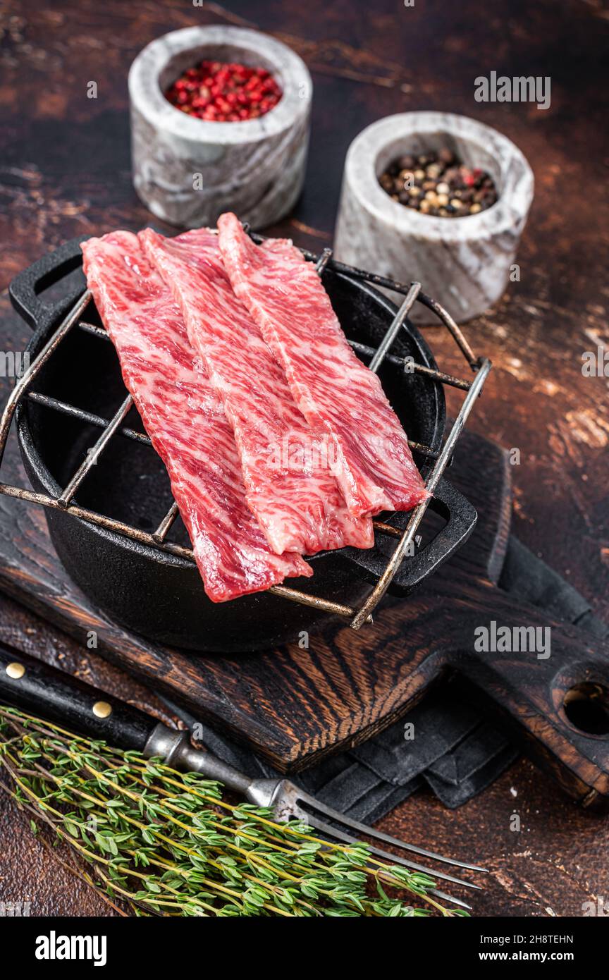 Premium raw sliced wagyu beef A5 steaks on a grill for yakiniku ...