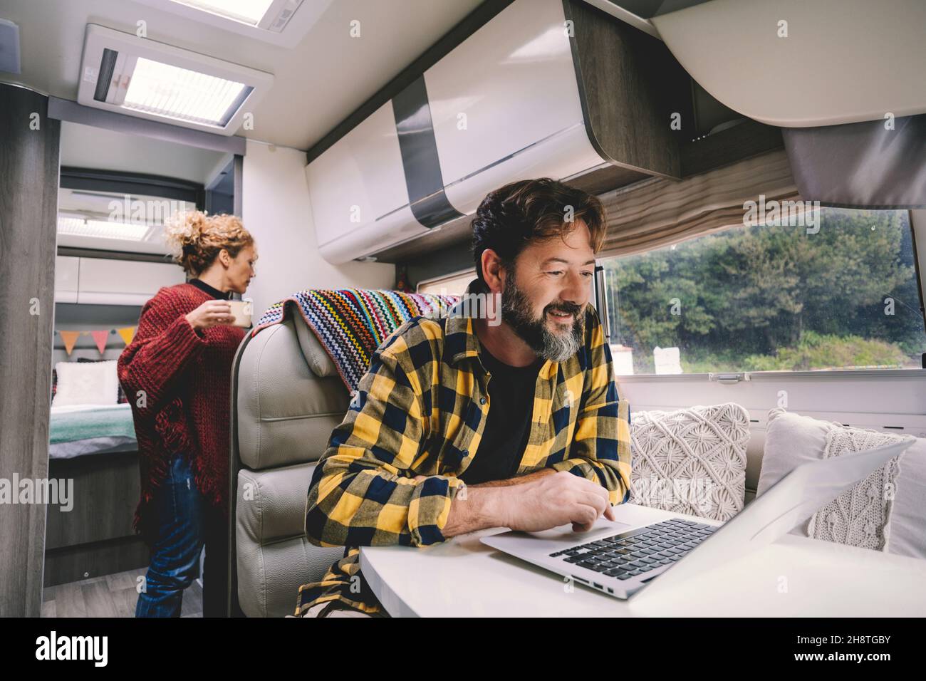 Alternative nomad lifestyle office workstation people. Man working on ...