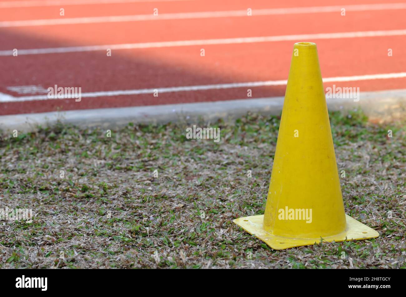 The yellow traffic cone is on the edge of the race track Stock Photo ...